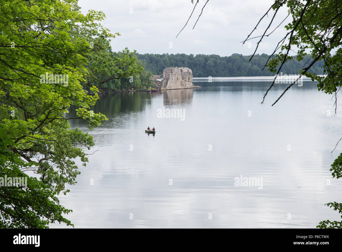 City Koknese, Latvia. Old river and green trees. Ruins and reflection ...