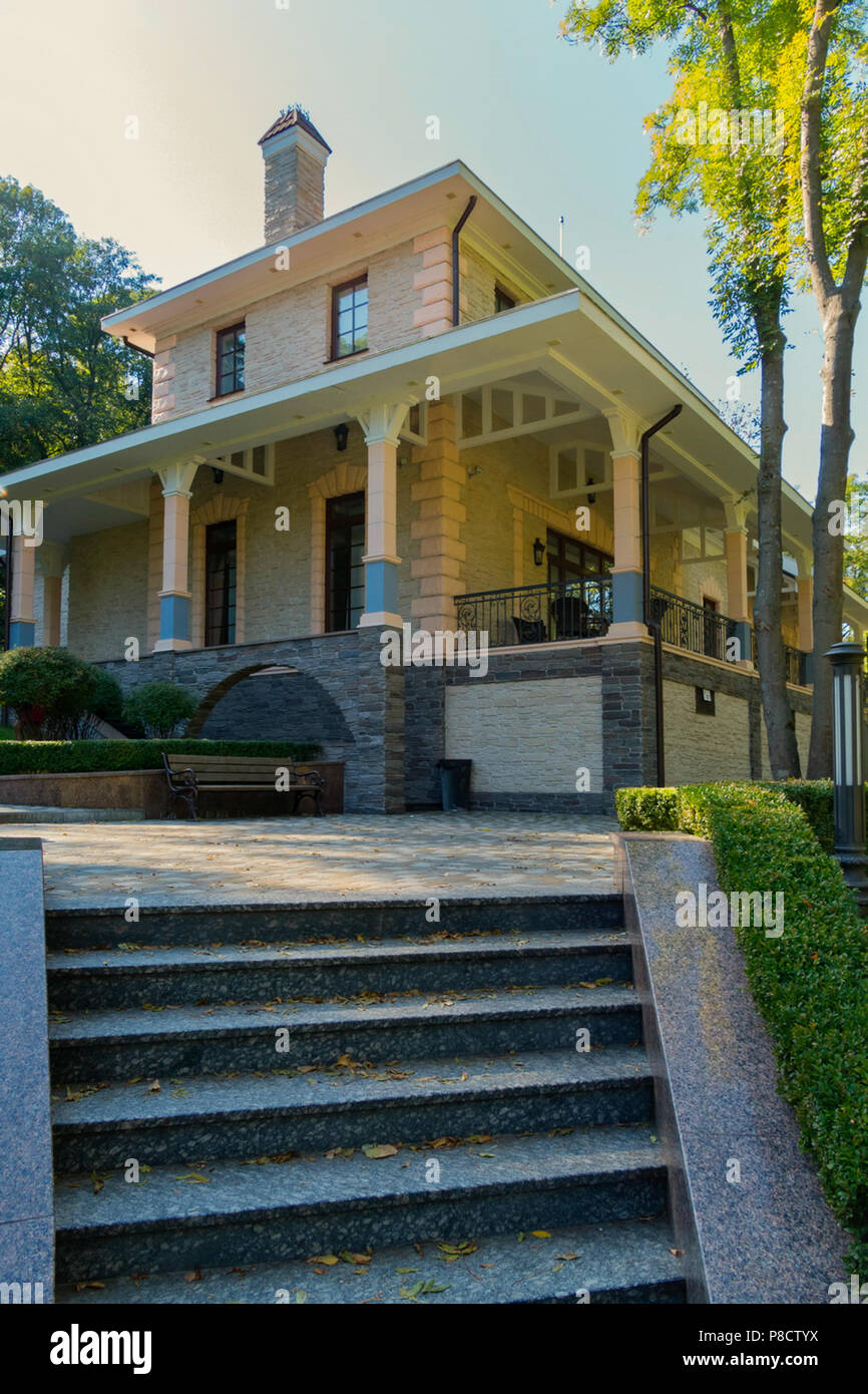 stone house with beige columns and steps in the foreground . For your ...
