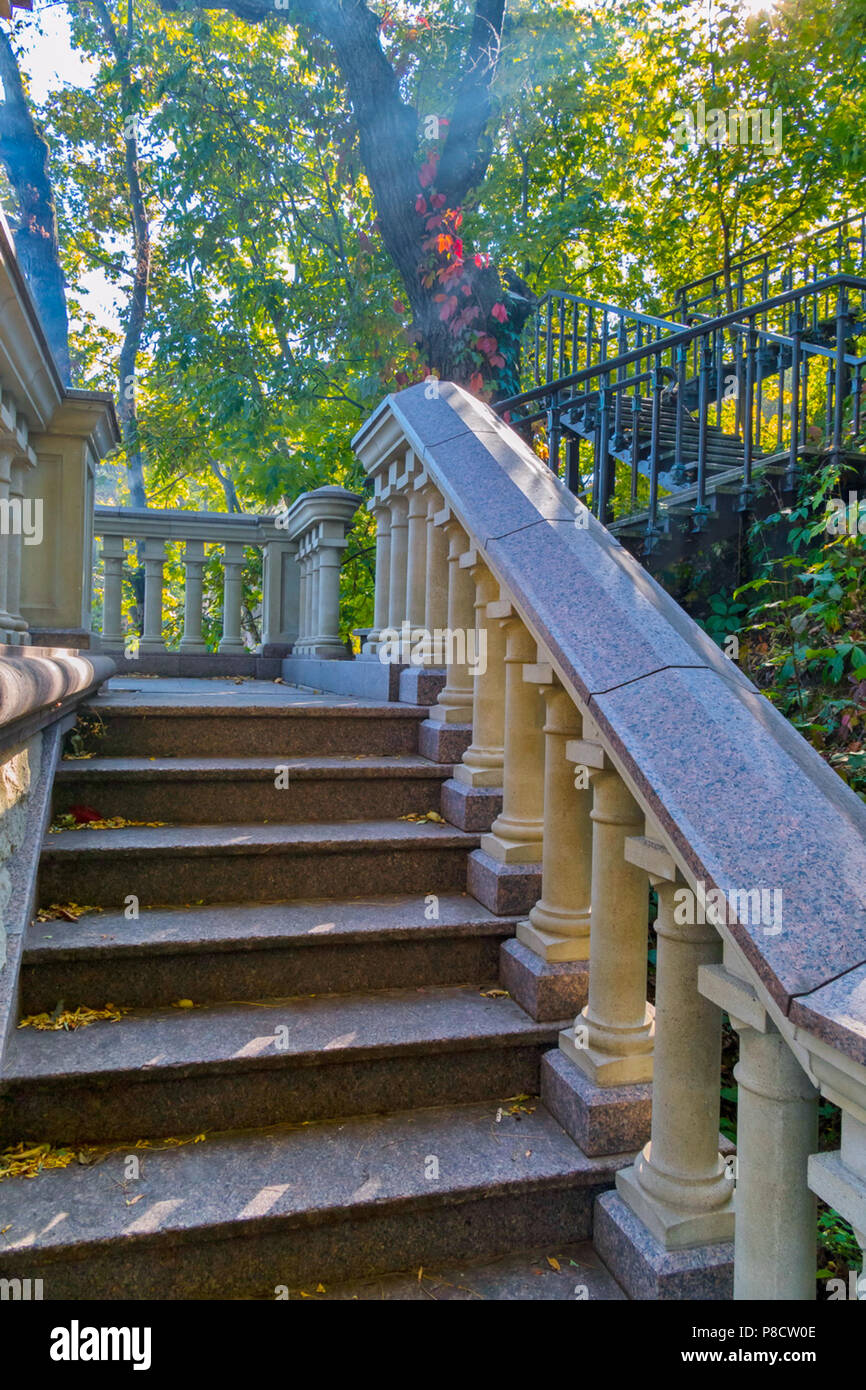 A multi-level ladder with beautiful railings in the form of columns ...