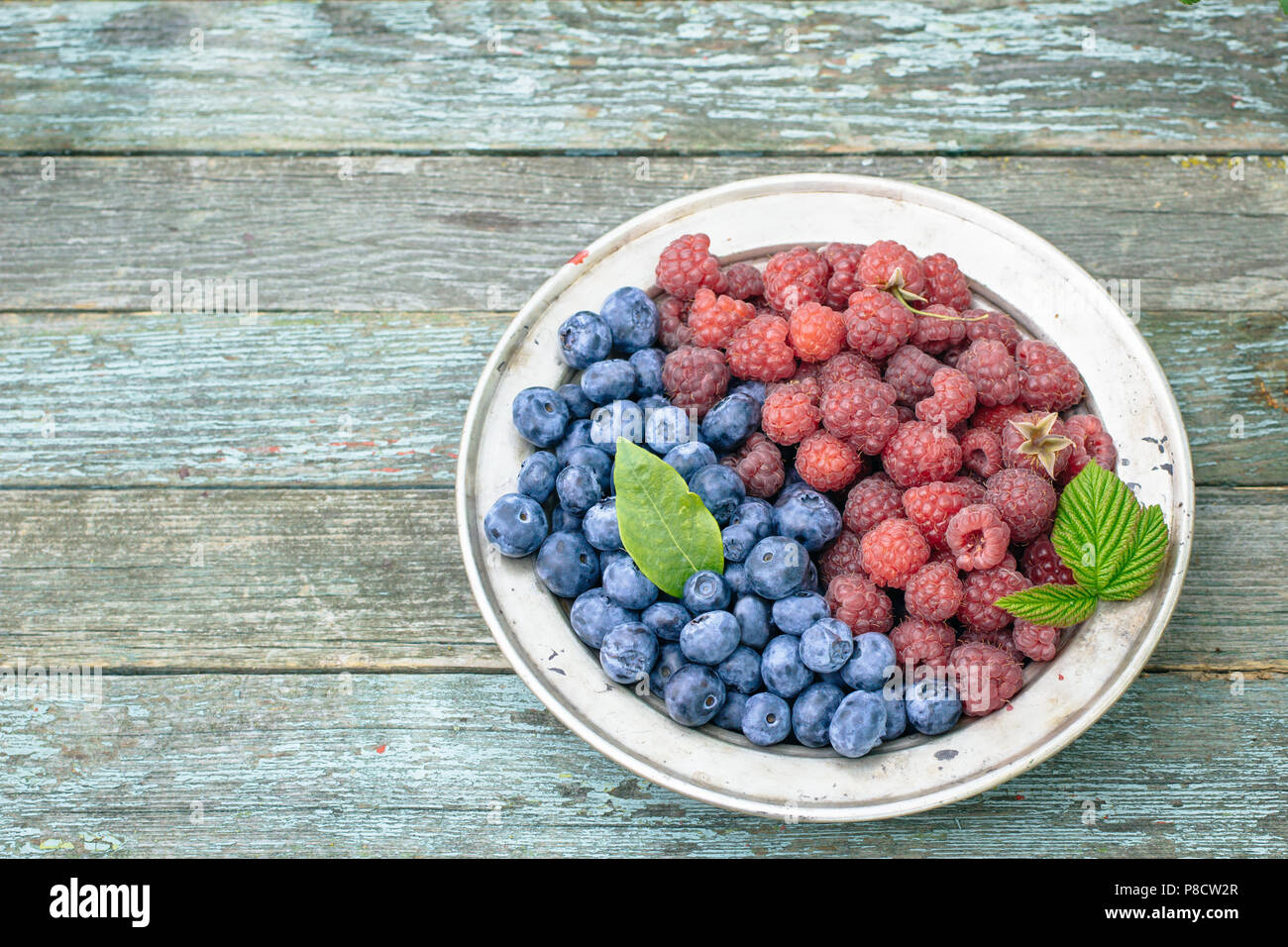 Blueberry and raspberry in plate Stock Photo - Alamy