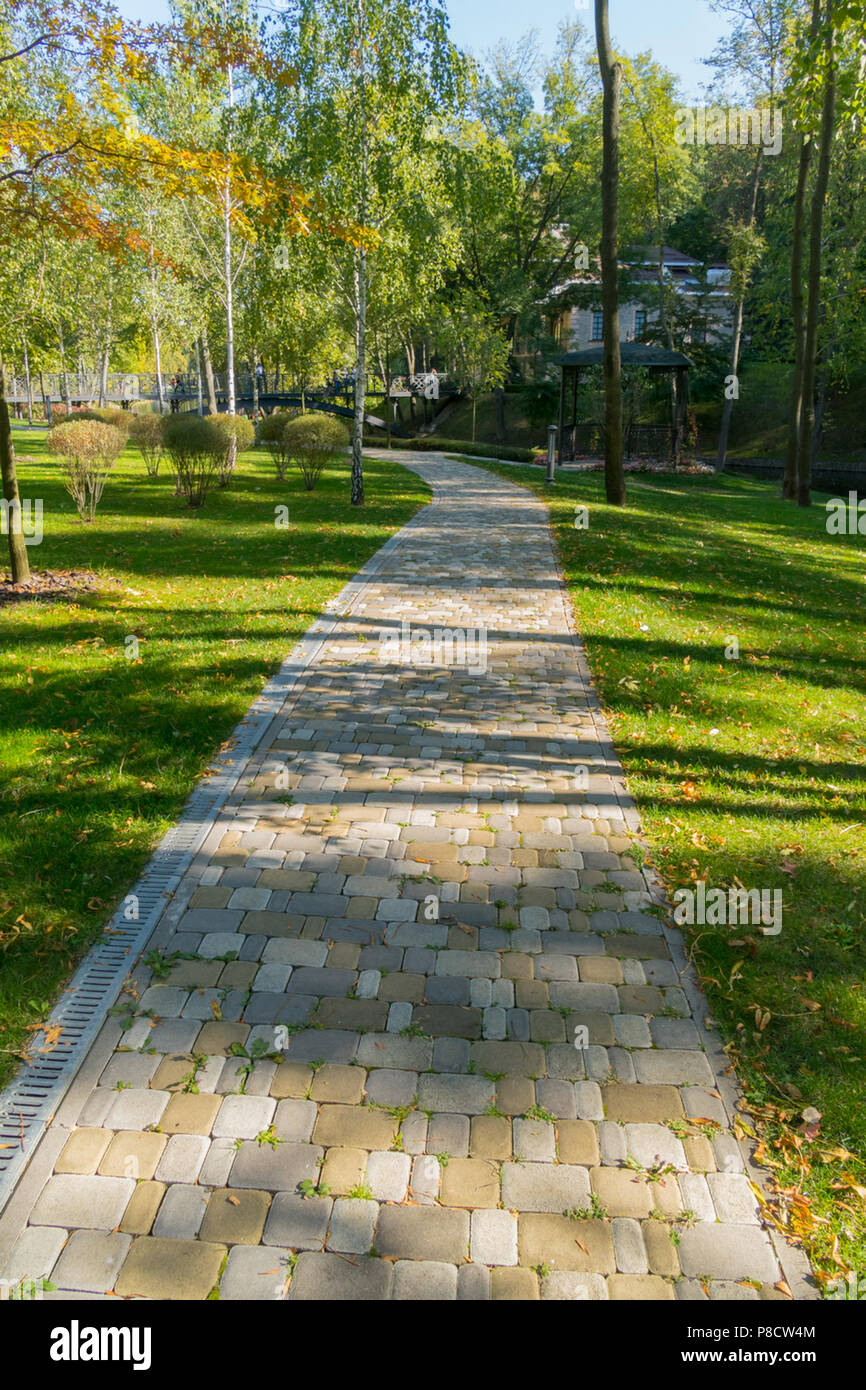 A path through the park. To the left is the greenery, to the right is ...