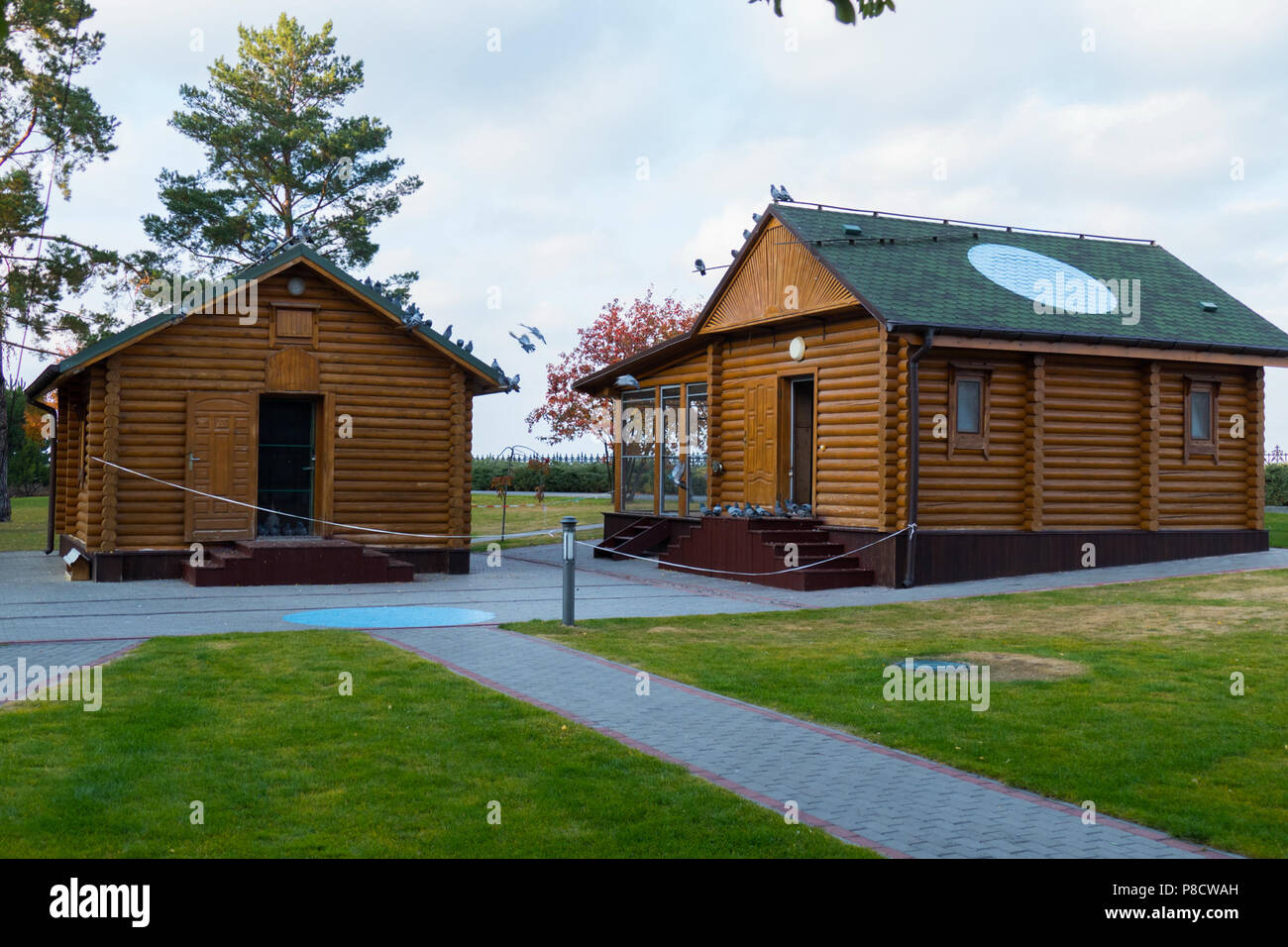 Two houses in the style of an old Russian log hut from wooden decks ...