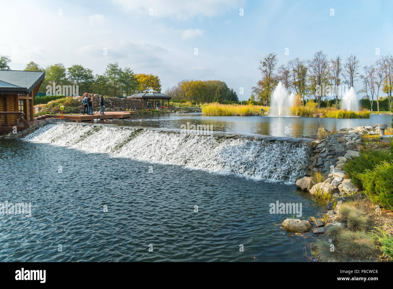a small artificial dam in the park on the background of fountains and ...