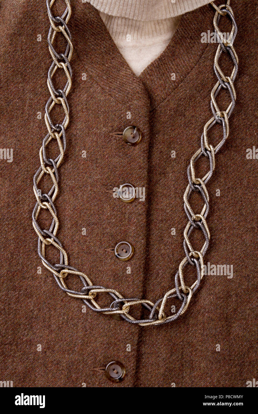 Extreme close up chain necklace on brown coat Stock Photo - Alamy