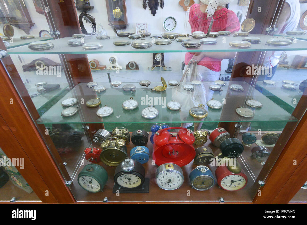 A large collection of various alarm clocks and pocket watches in the ...