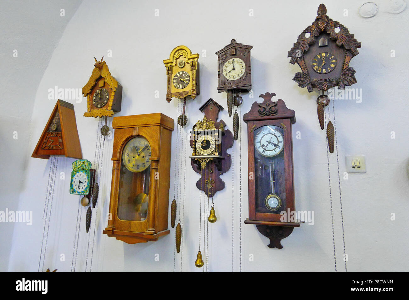 a room with exhibits of ancient clocks of different eras in Palanok ...