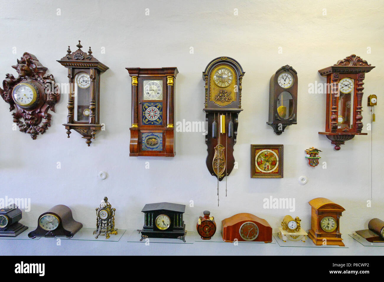 Exposition with a huge number of different ancient wooden clockwork ...