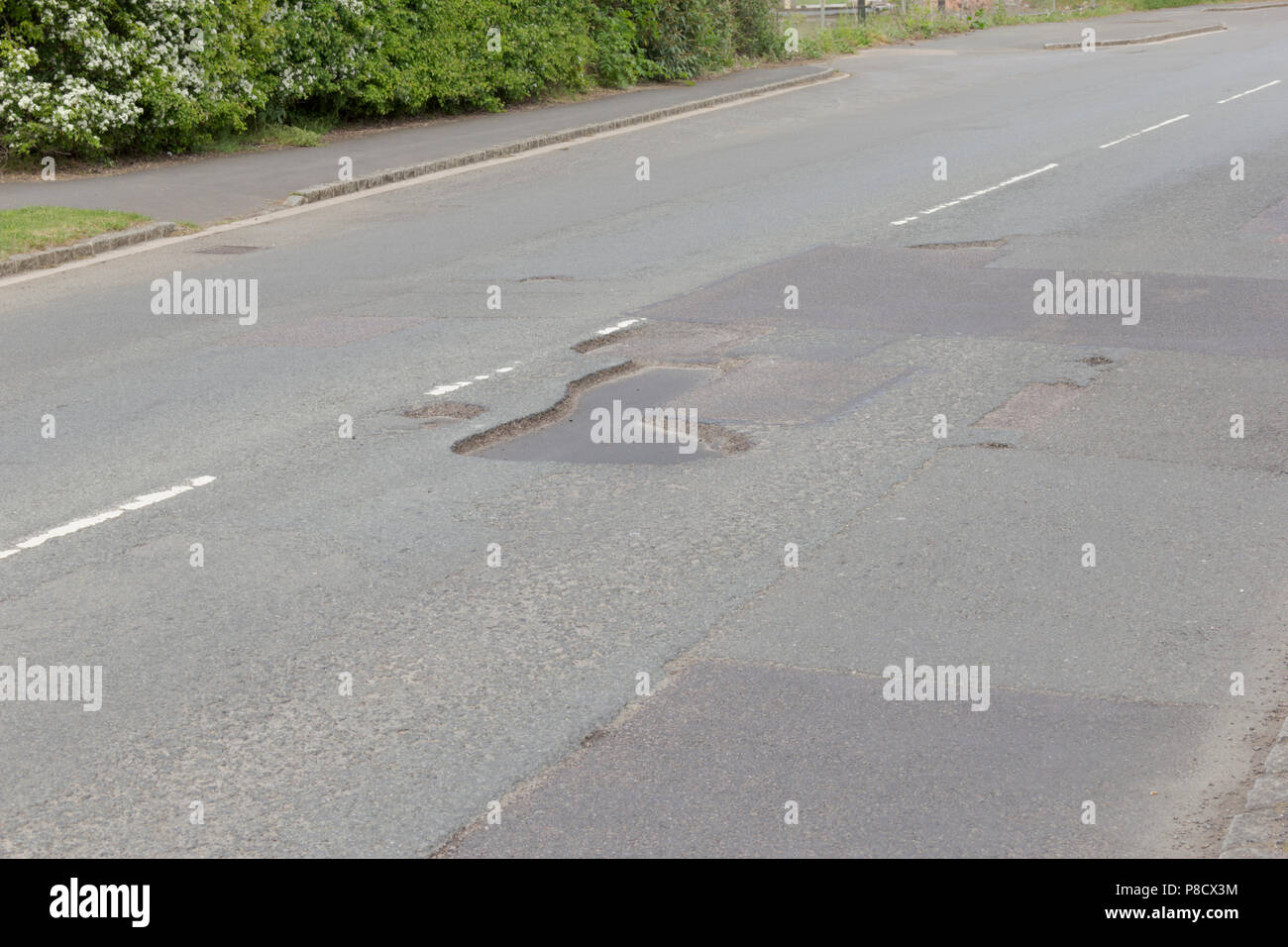 Pot holes in Carterton, Oxfordshire UK. 13th May 2018. UK Weather: Pot ...