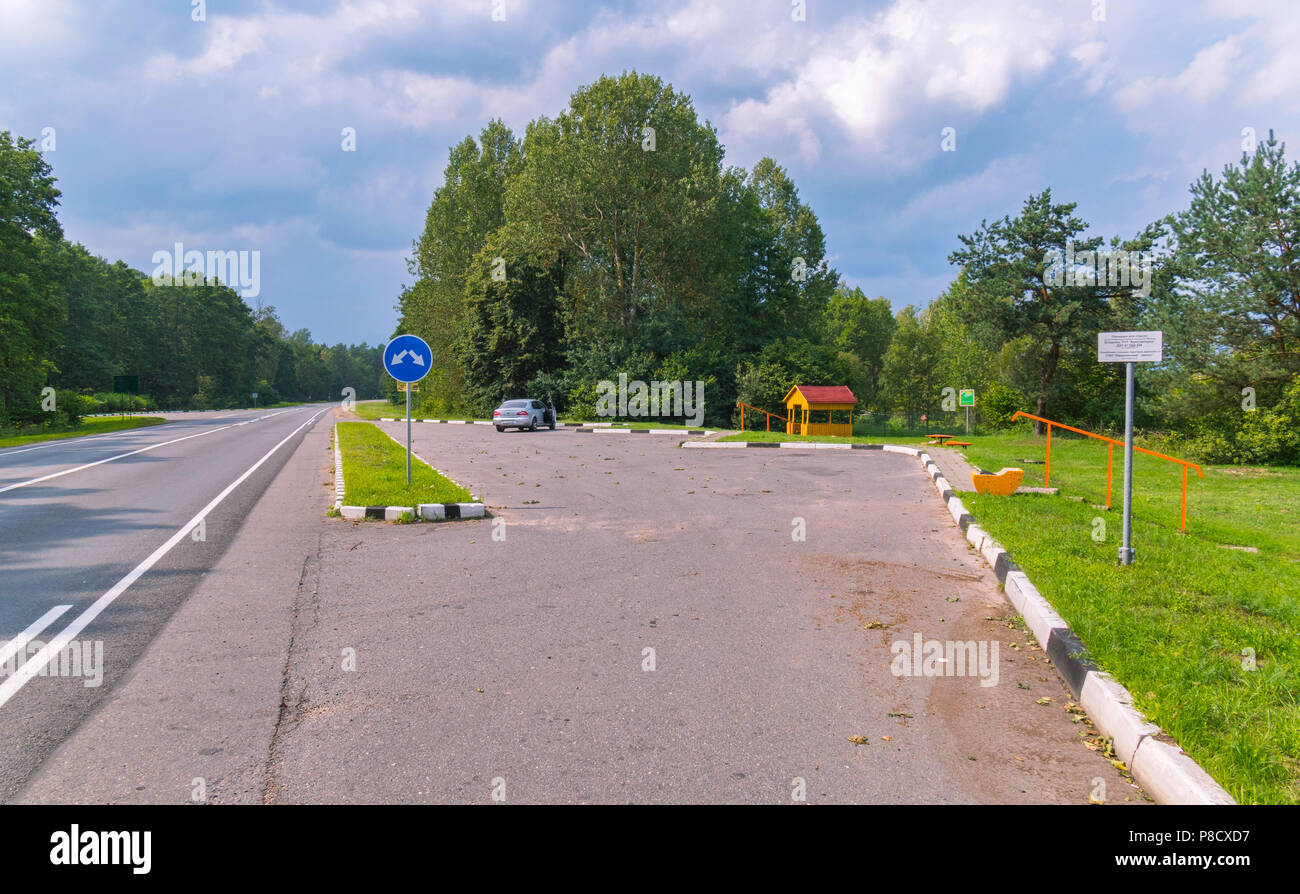 The car stopped at the side of the road against the backdrop of a ...