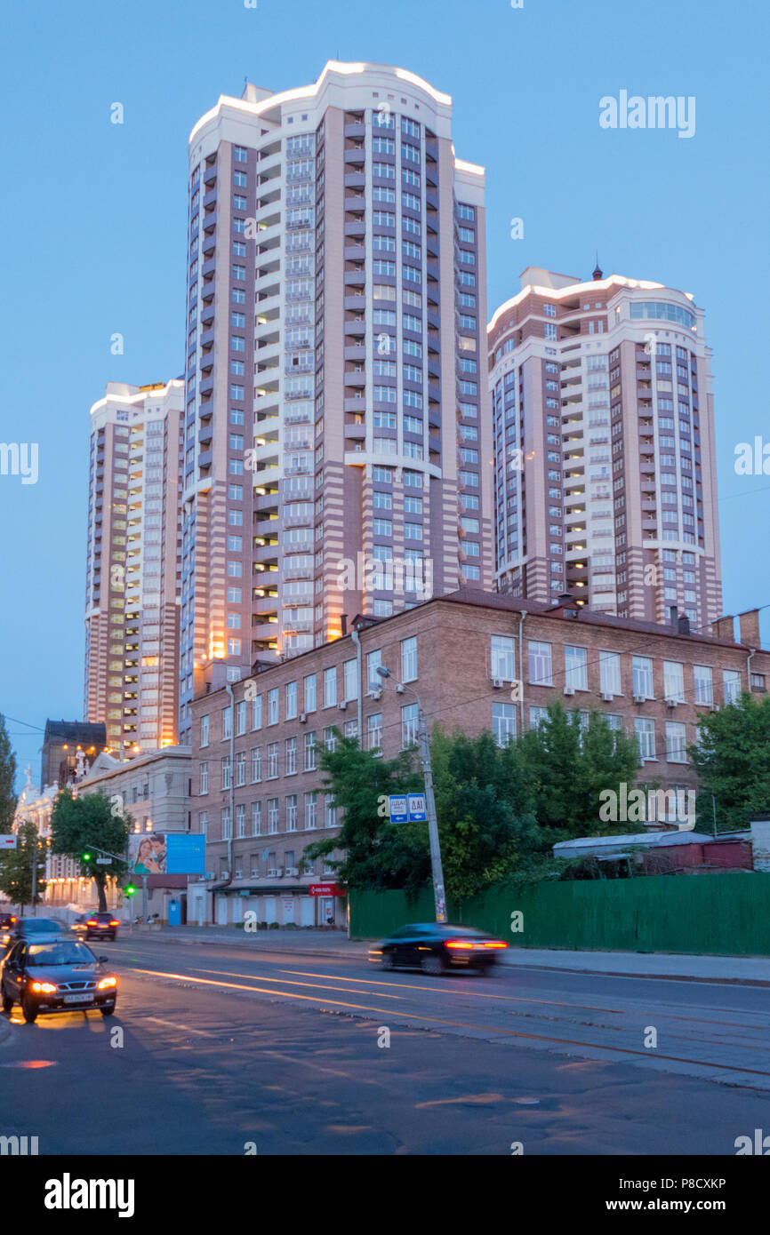 three high-rise new buildings with evening illumination . For your ...