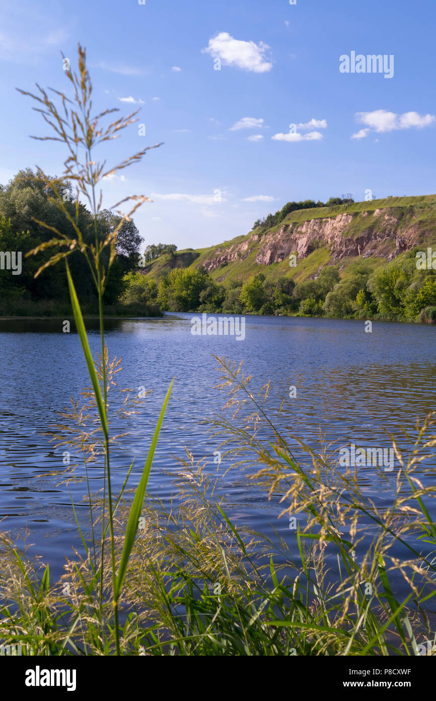 Beautiful blue deep lake on a background of green rocky mountains . For ...