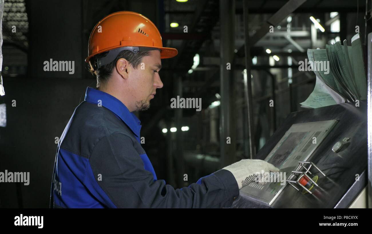 Operator monitors control panel of production line. Manufacture of ...