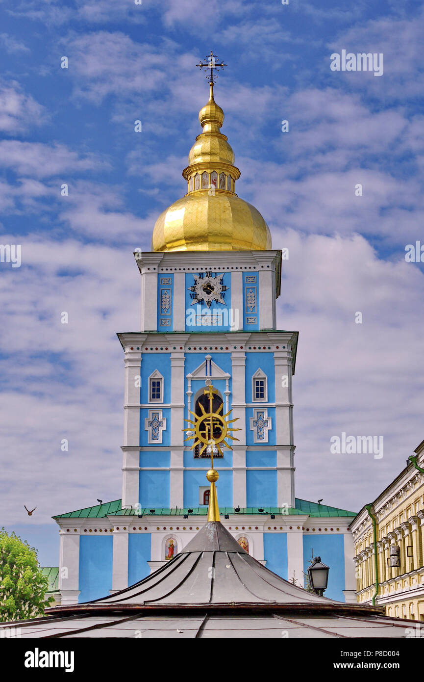 Beautiful blue church with golden domes and crosses against a cloudy ...