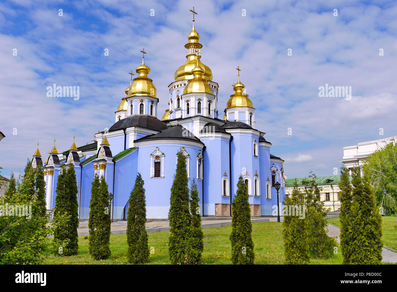 A large massive blue temple with a black roof and golden domes on a ...