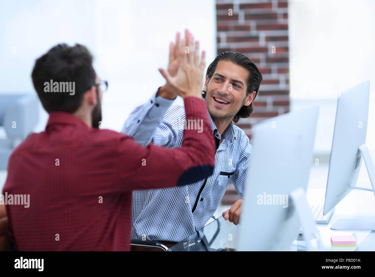 happy employees giving each other high five Stock Photo - Alamy