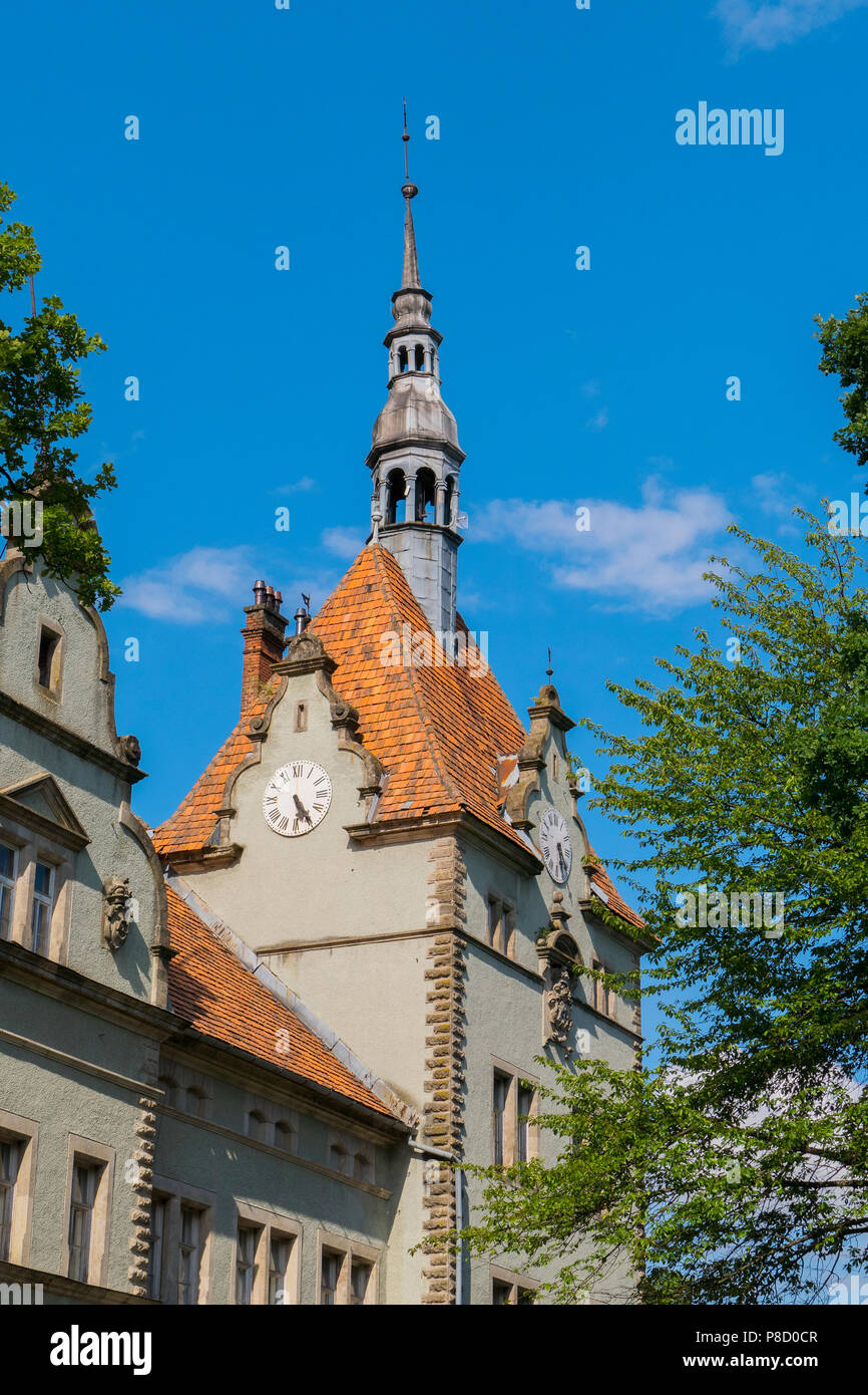 An ancient house with beautiful architecture with clock faces on two ...