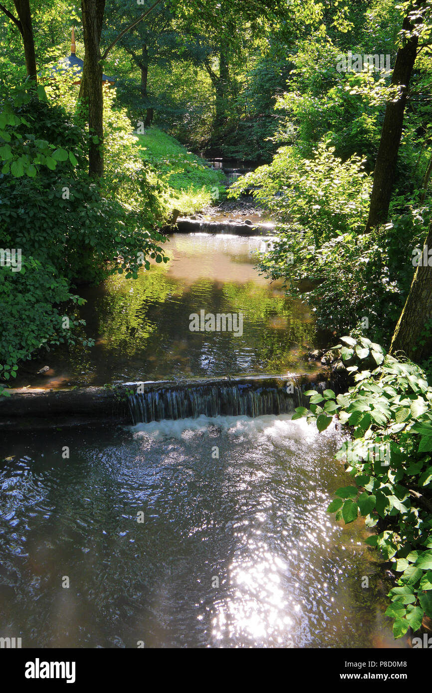 A fast river flowing with large water currents against the background ...