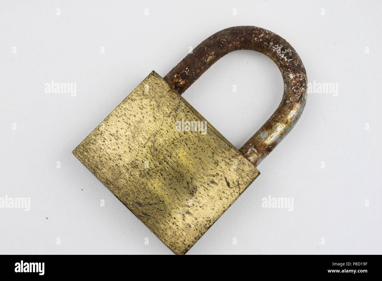 Brass padlock on a white table. Accessories for locking and securing ...