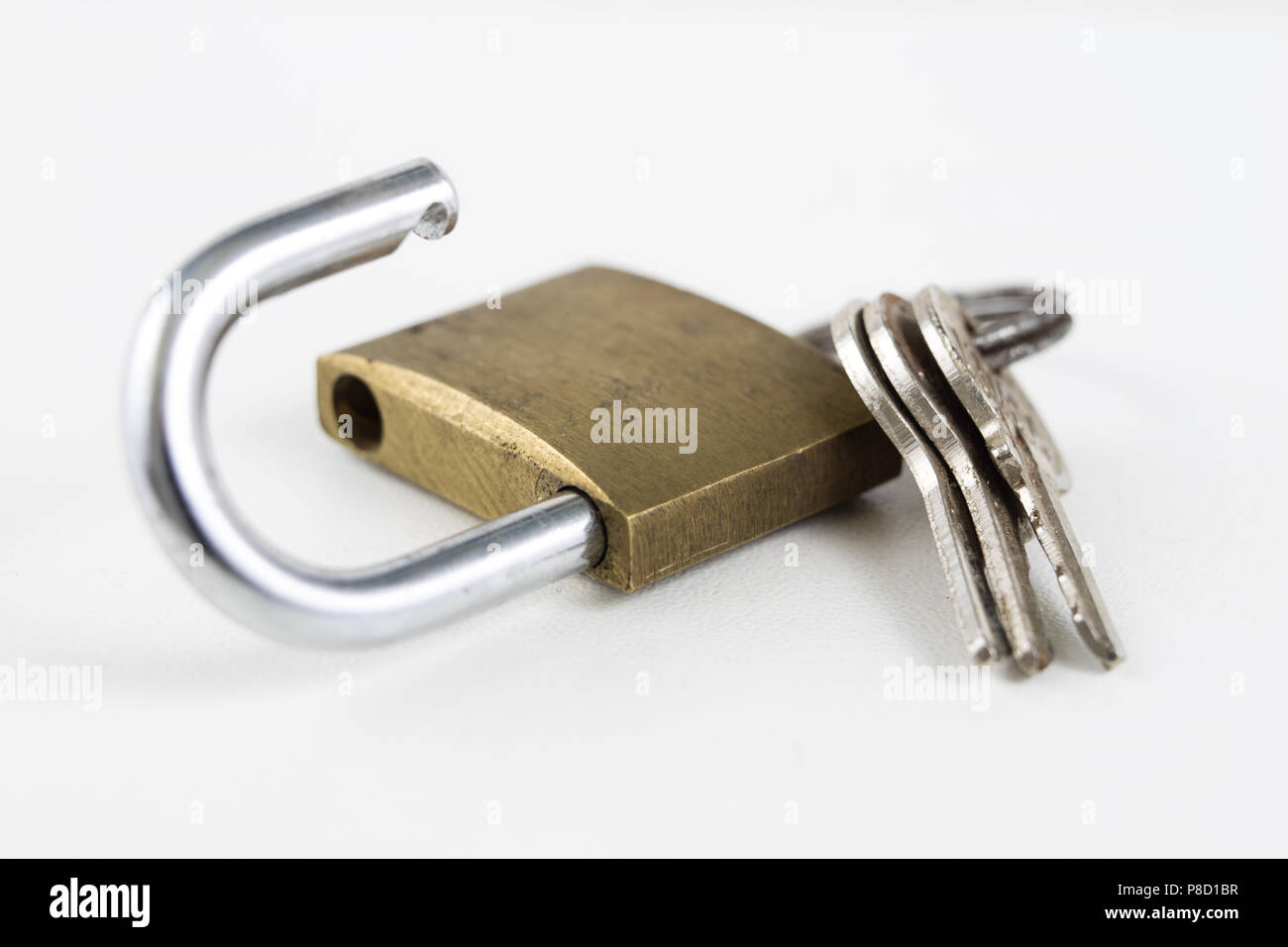 Brass padlock on a white table. Accessories for locking and securing ...