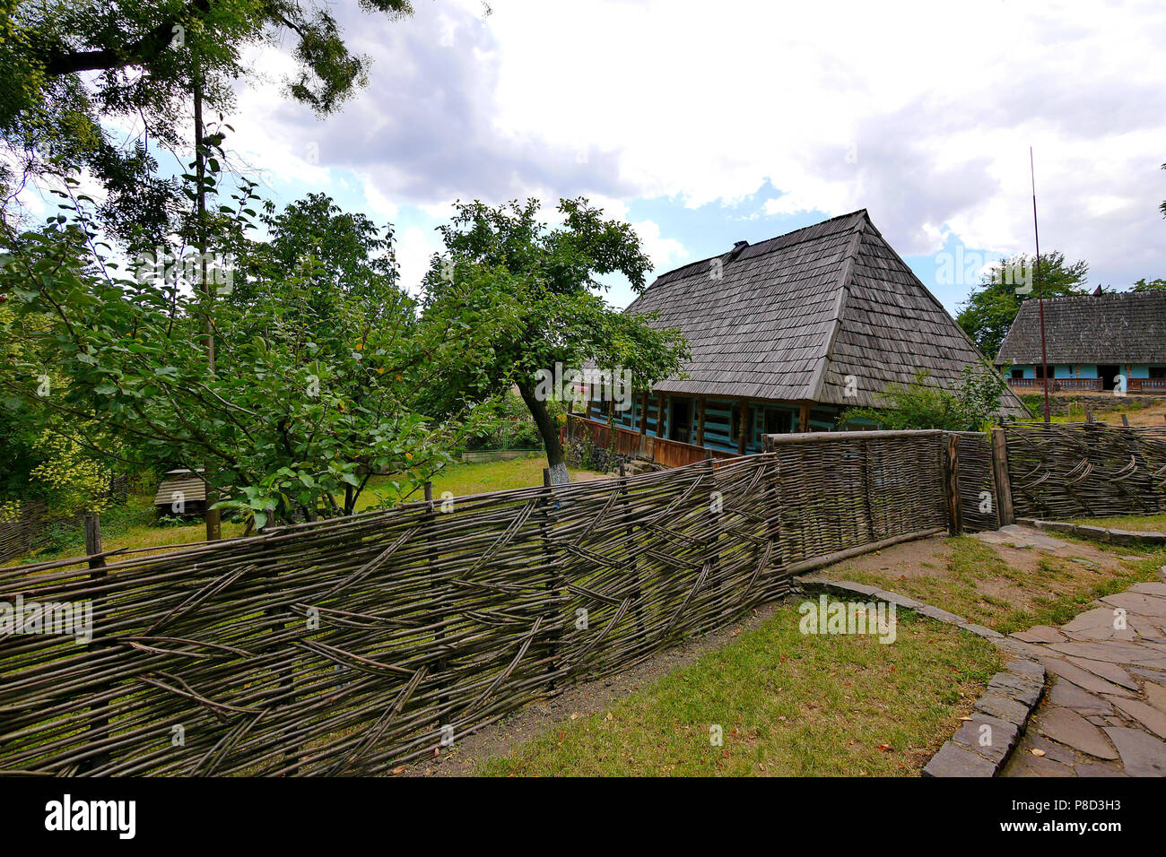 wicker fence and gates enclosing a rural house with a garden . For your ...