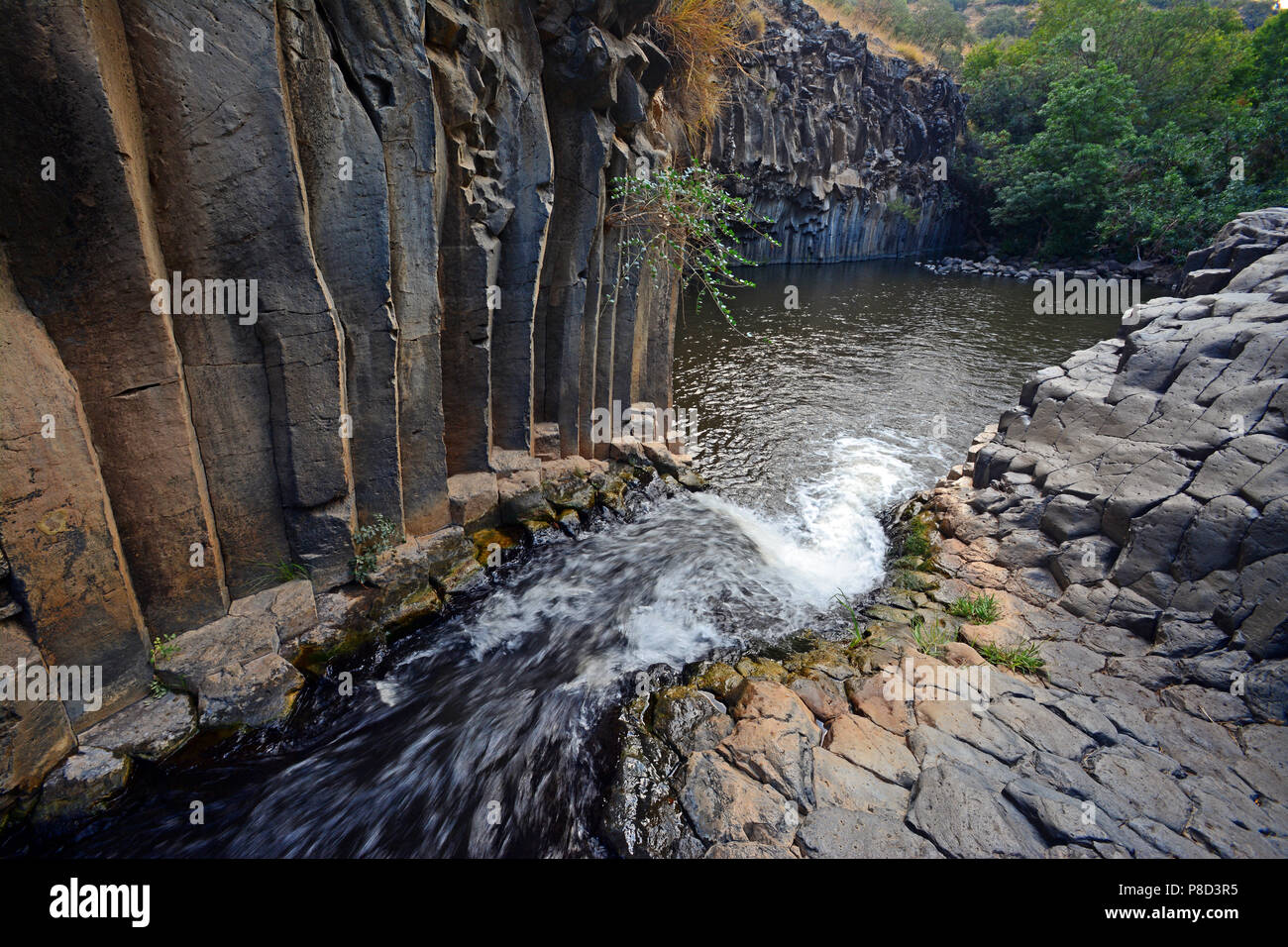 Meshushim canyon bed surrounded by impressive hexagonal basalt pillars ...