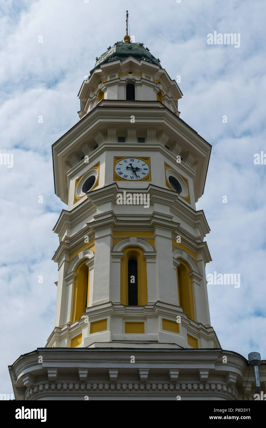 Ancient beautiful tower with a clock with a pointed spire on the top ...