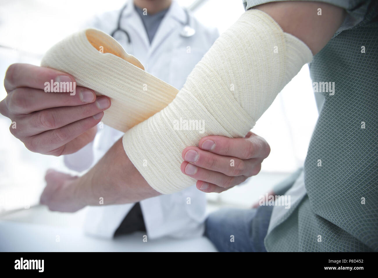 Doctor applying bandage to patients hand and wrist hi-res stock ...