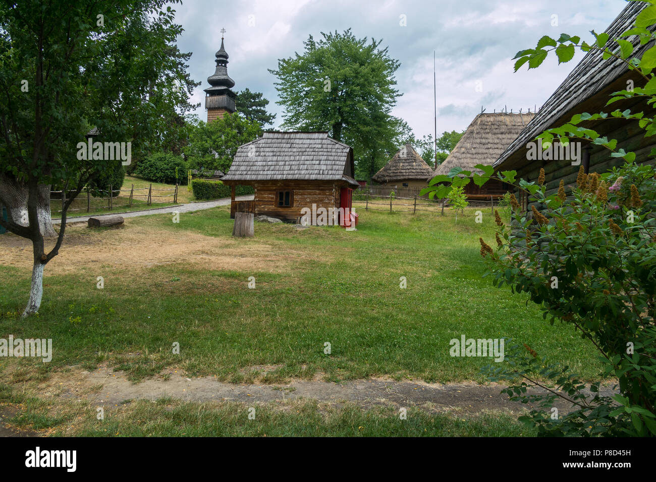 A small house with one window standing on a green grass in a historic ...