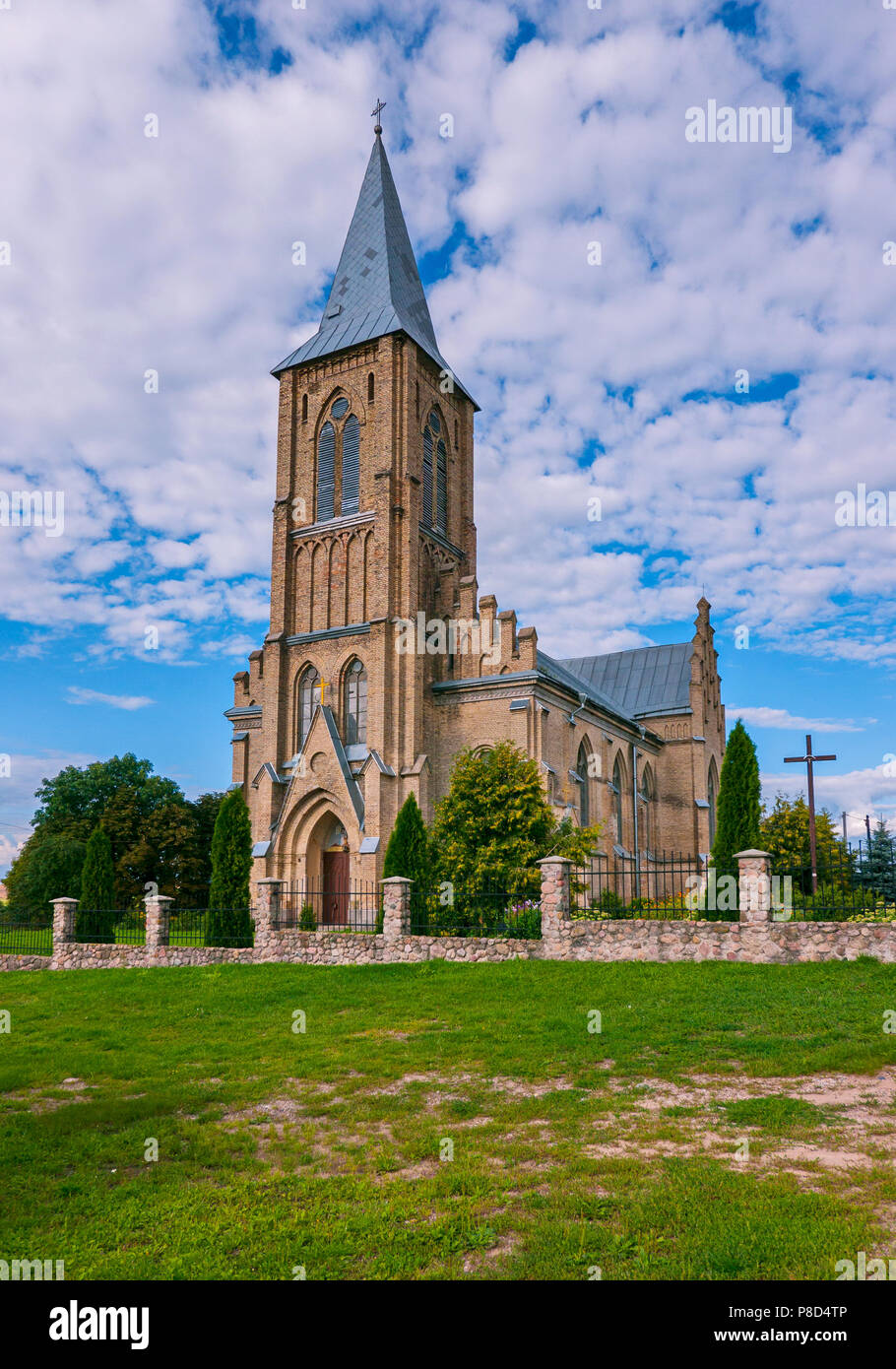 The building of a high Catholic church with a cross on a pico-shaped ...