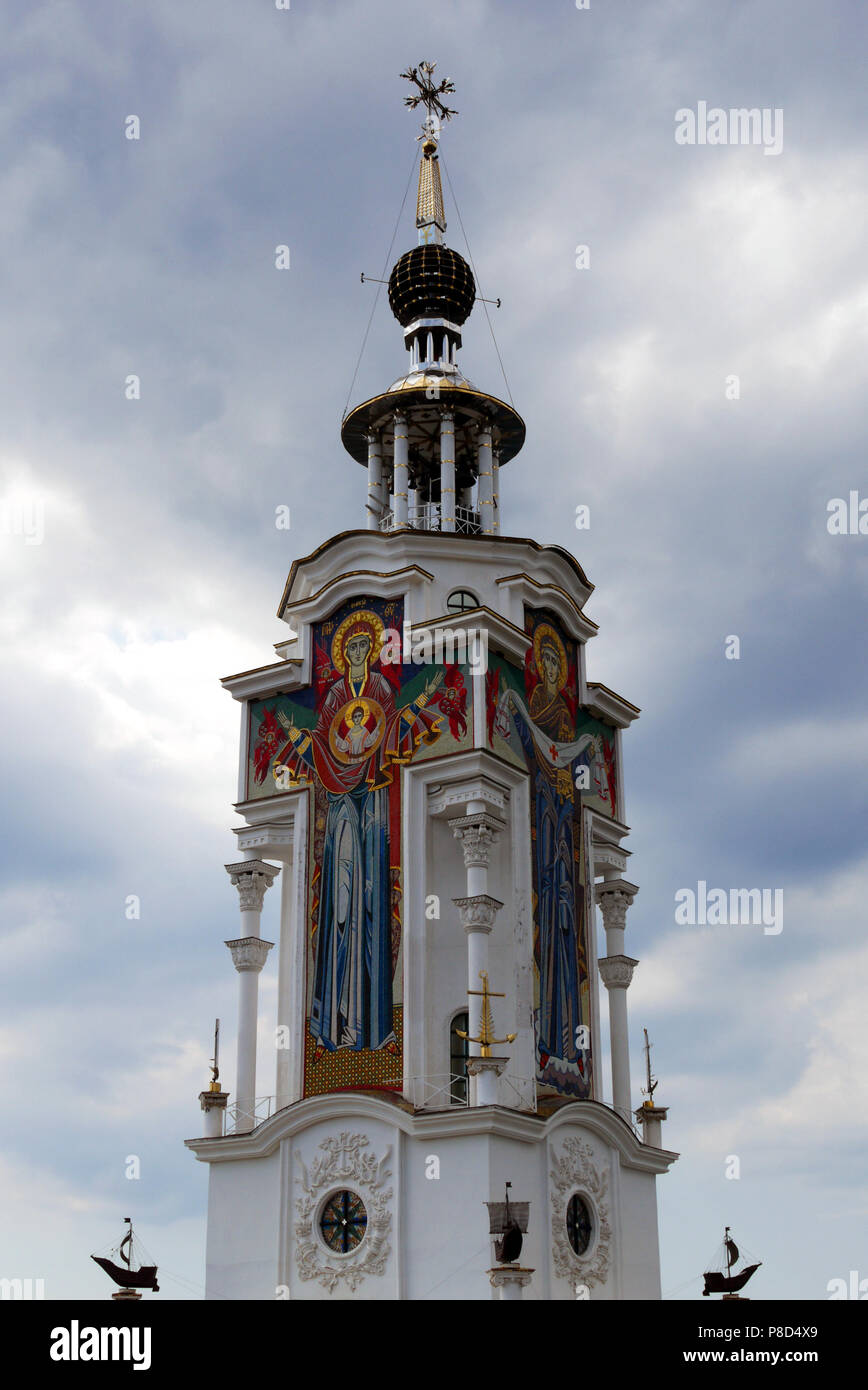 A beautiful high church building with saints' faces on the walls with a ...
