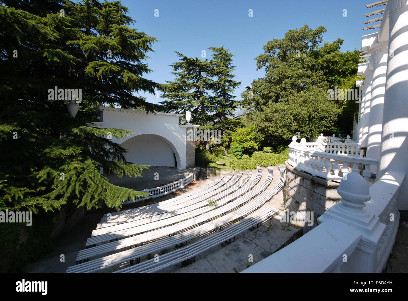 Summer amphitheater with several rows of benches, a spacious white ...
