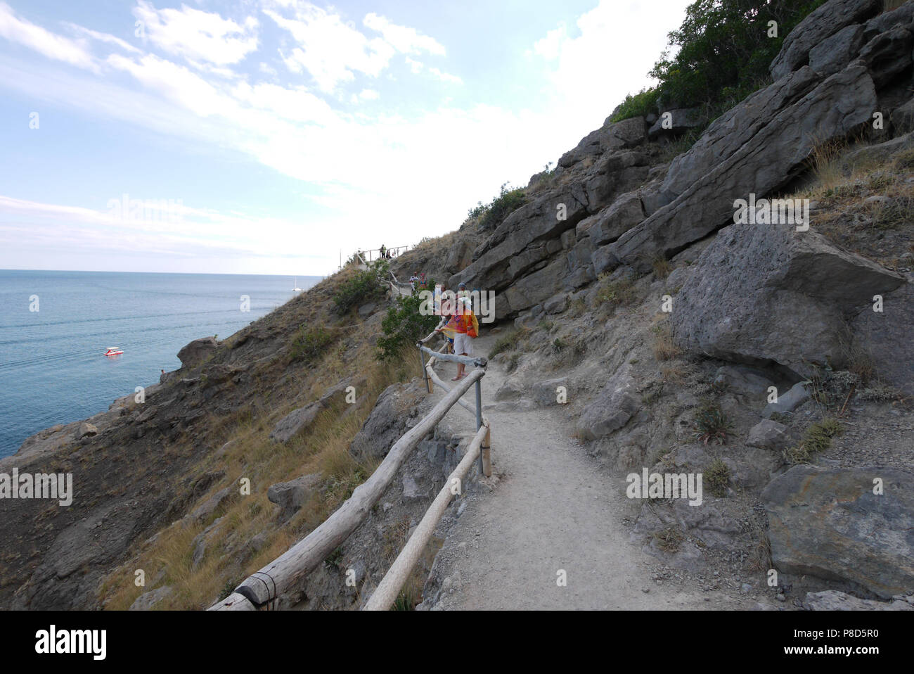 Rocky country near the sea. On the slope of one of the cliffs there is ...