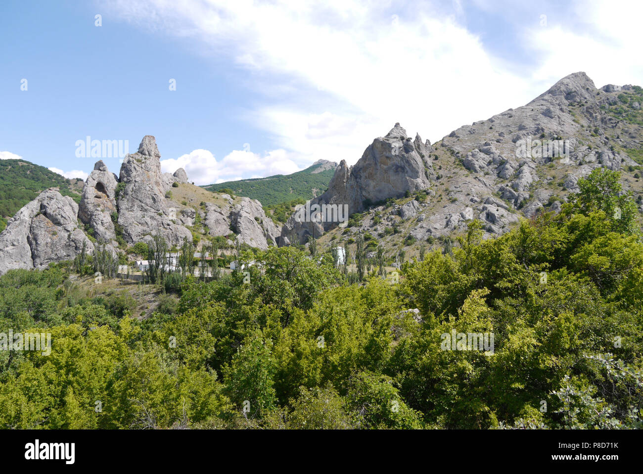 a landscape of spiny stone hills with a settlement in the valley ...