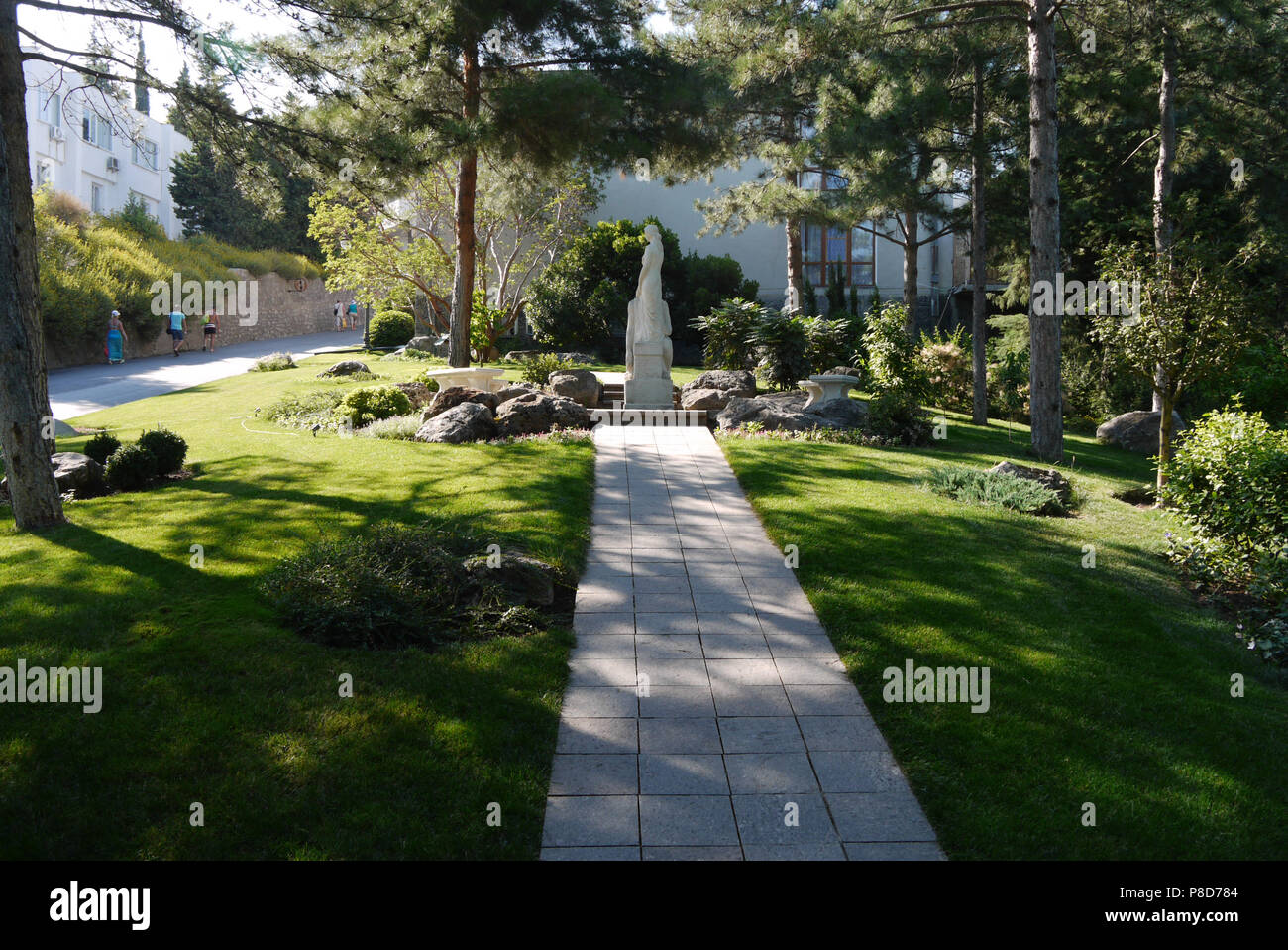 the path leading to a white statue surrounded by stones . For your ...