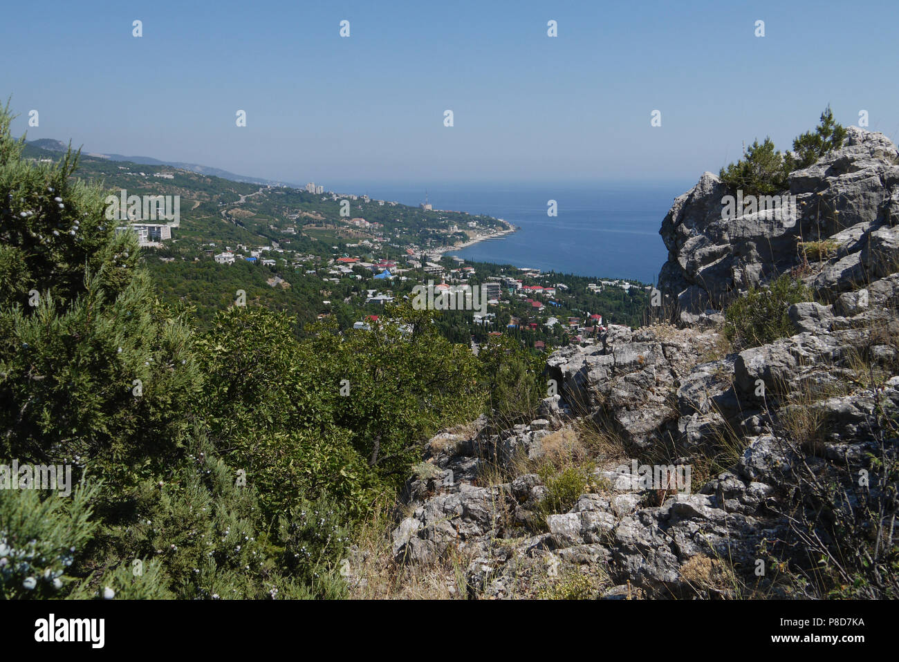small grass-covered rocks on the background of a beautiful coastal town ...