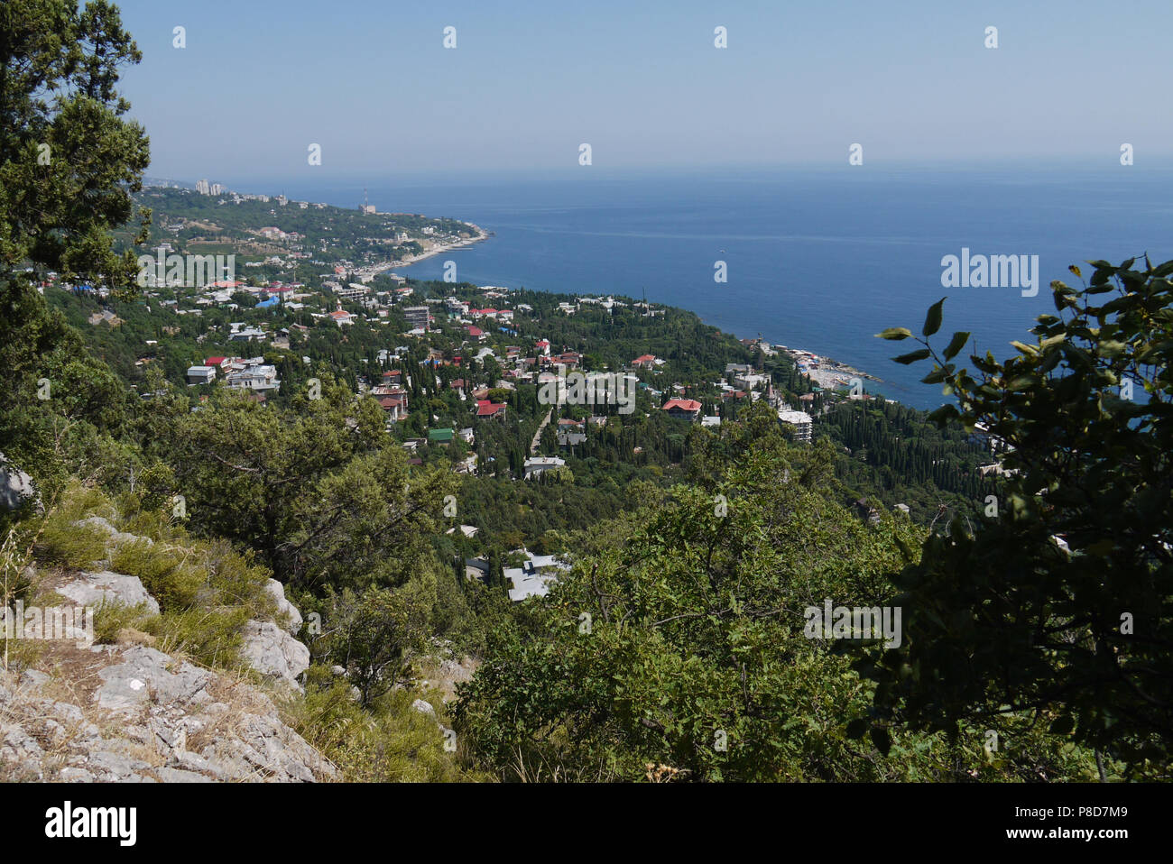 small grass-covered rocks on the background of a beautiful coastal town ...