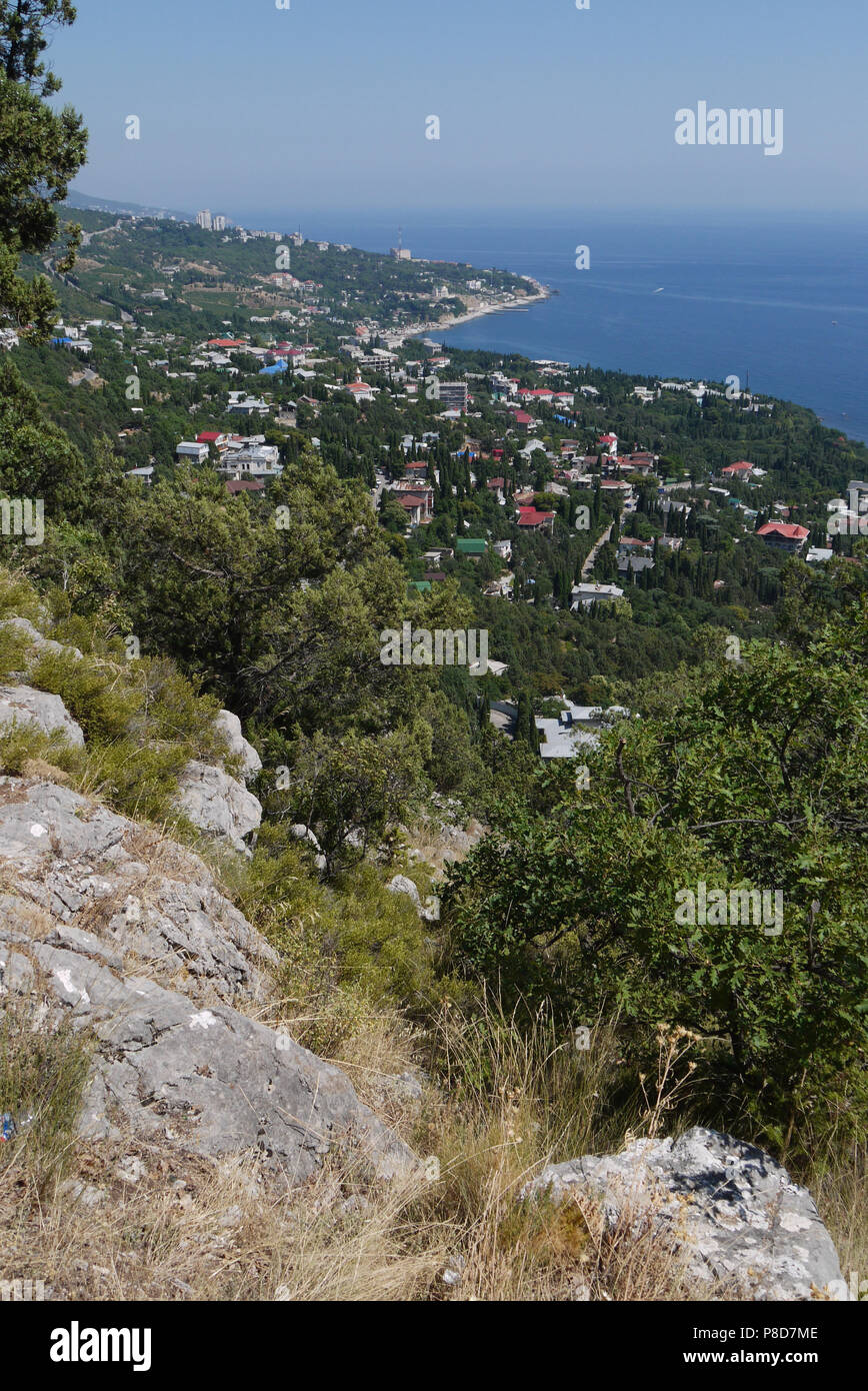 small grass-covered rocks on the background of a beautiful coastal town ...