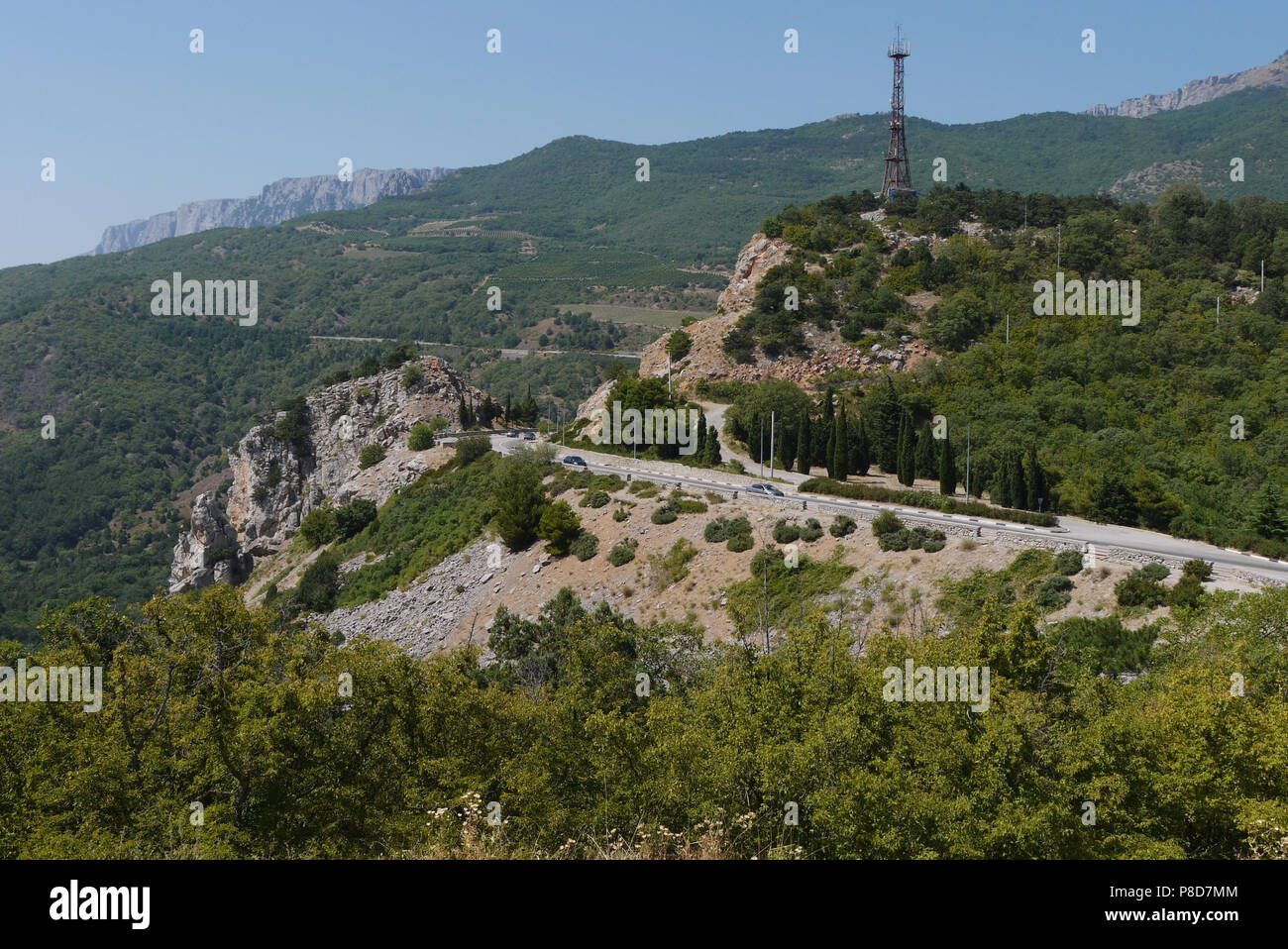 the rocky road is rolled up against the background of high mountains ...