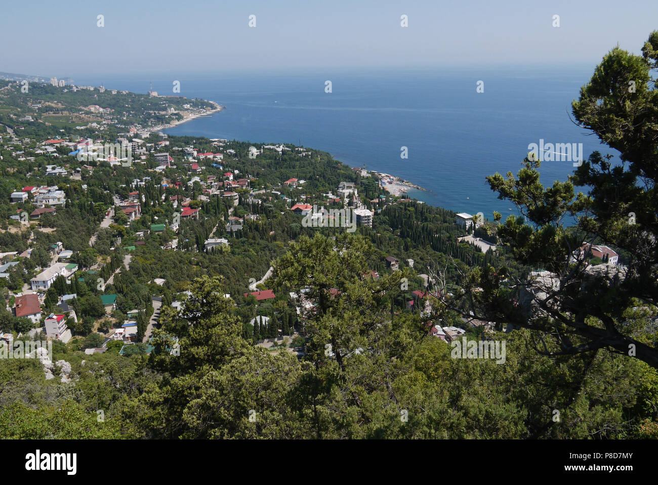 small grass-covered rocks on the background of a beautiful coastal town ...