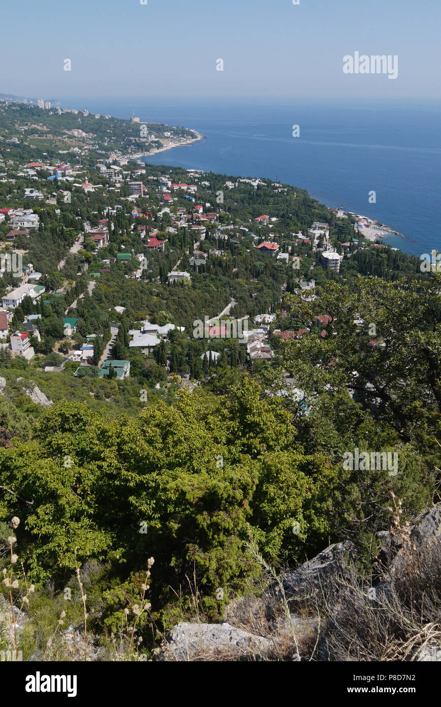 small grass-covered rocks on the background of a beautiful coastal town ...