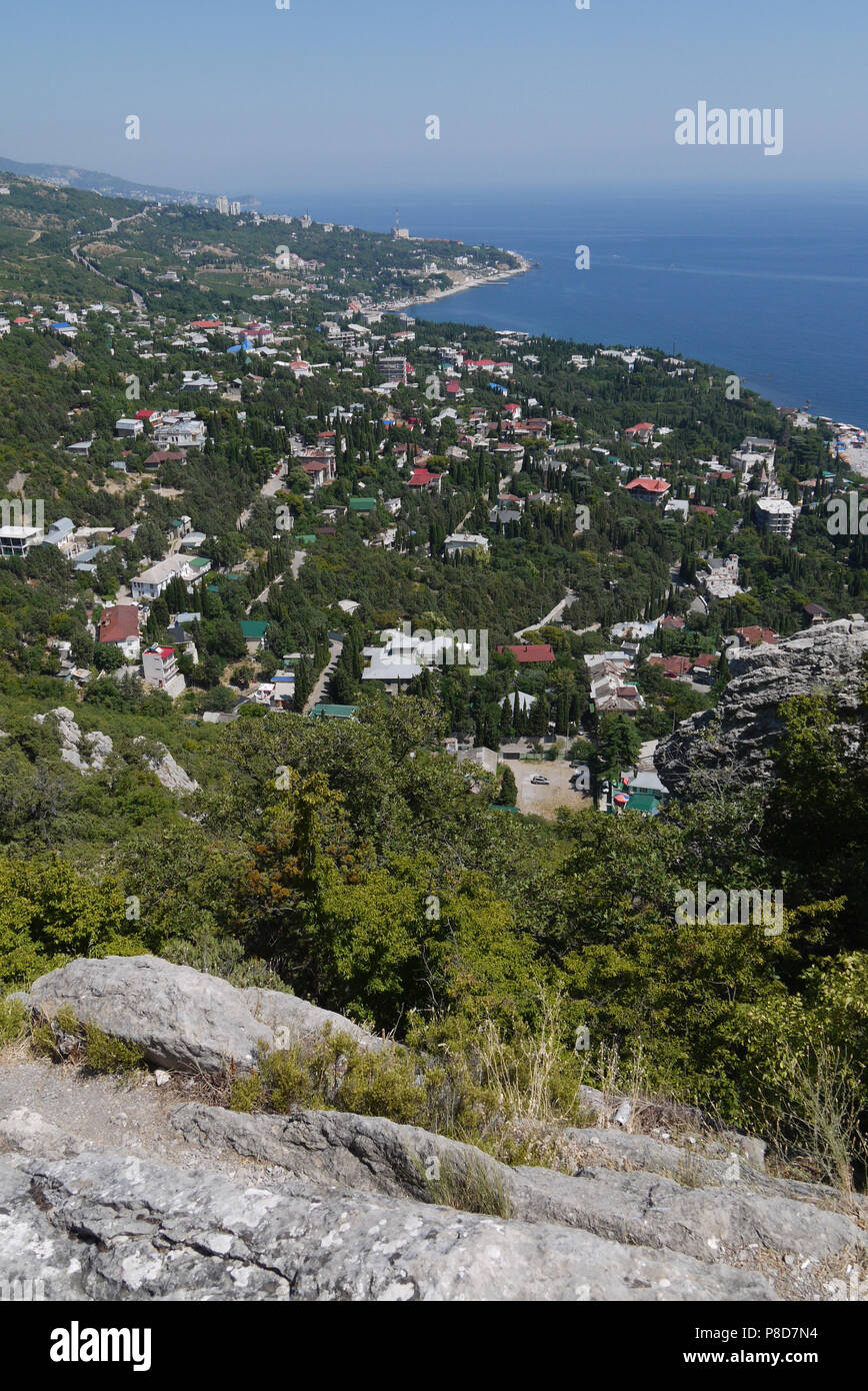 small grass-covered rocks on the background of a beautiful coastal town ...