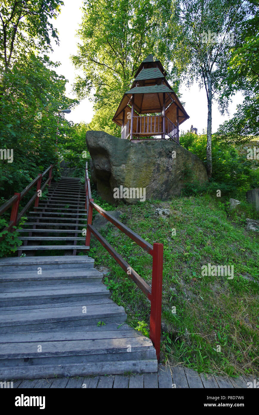 small narrow stairs leading to a gazebo surrounded by tall trees . For ...