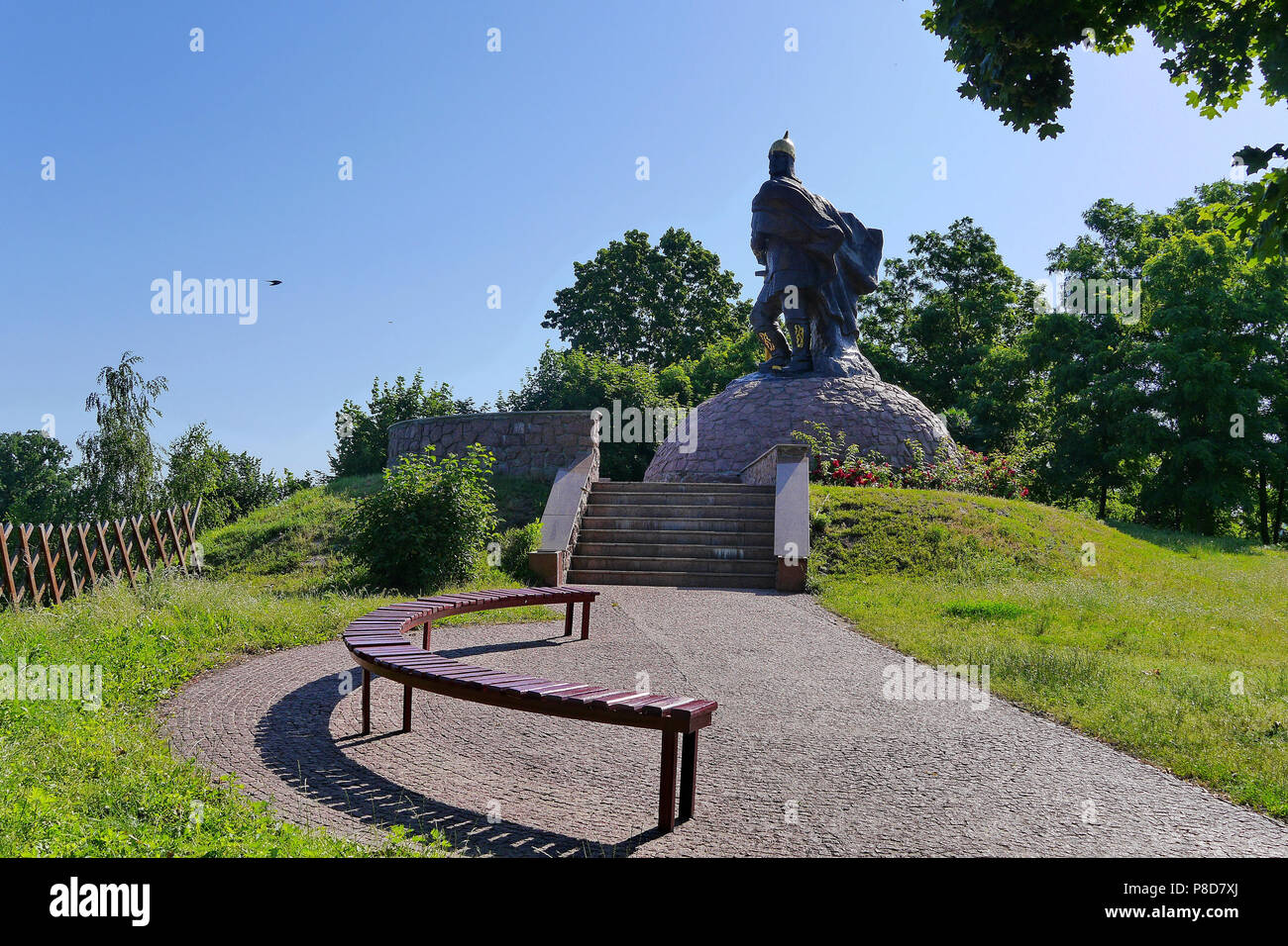 High statue of a knight under a blue sky on the background of beautiful ...