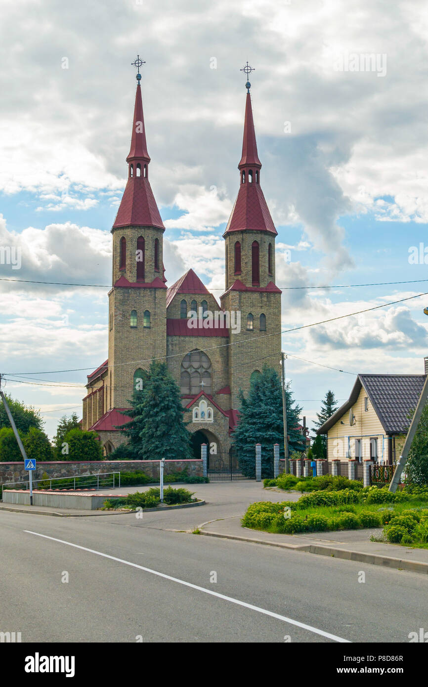 Beautiful brick building with a red roof in a Gothic style on the blue ...