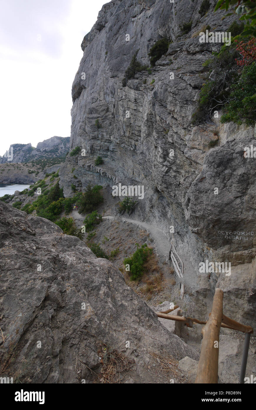 narrow rocky path under high steep mountains . For your design Stock ...