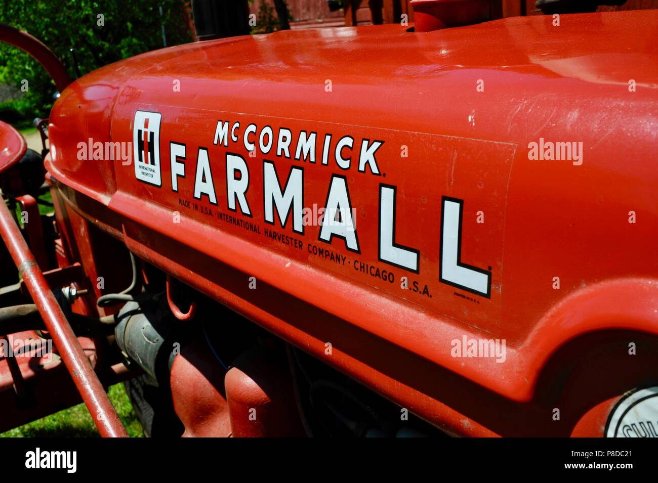 Well maintained, red McCormick Farmall farm tractor parked on farmstead ...