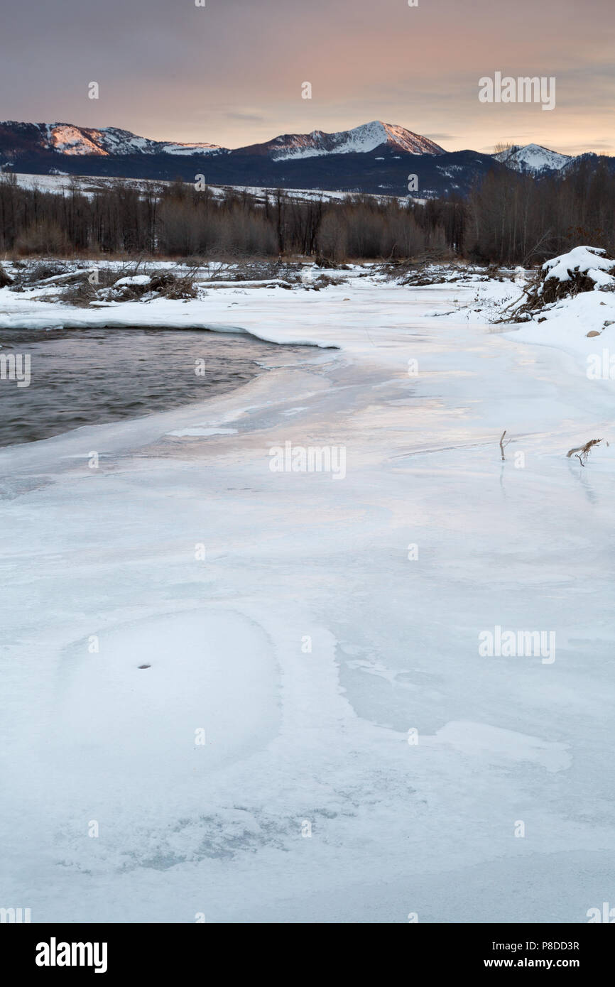 An iced over river bank along the Gros Ventre River freezing below ...
