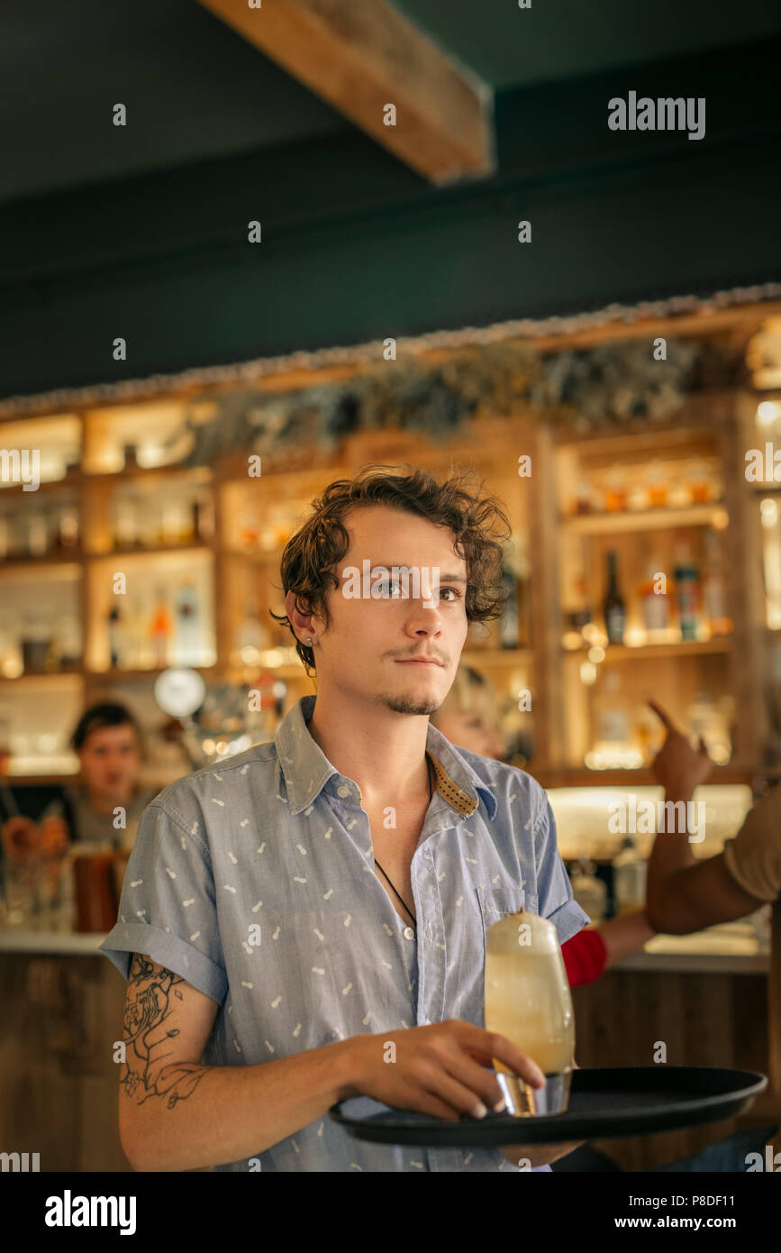 Waitress waiter holding tray in hi-res stock photography and images - Alamy