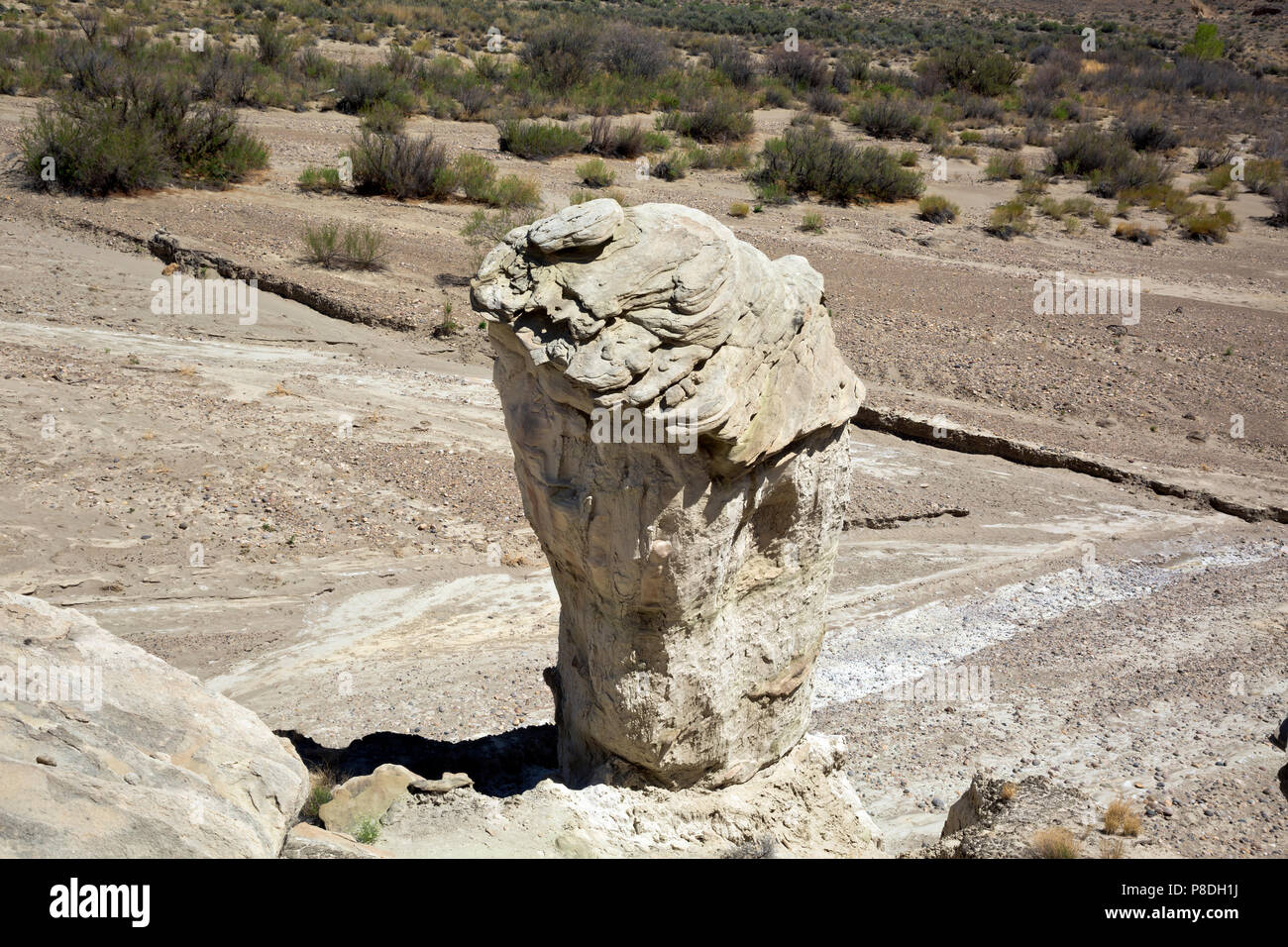 UTAH - Boulder perched on an eroded base rock marks the entrance to the ...