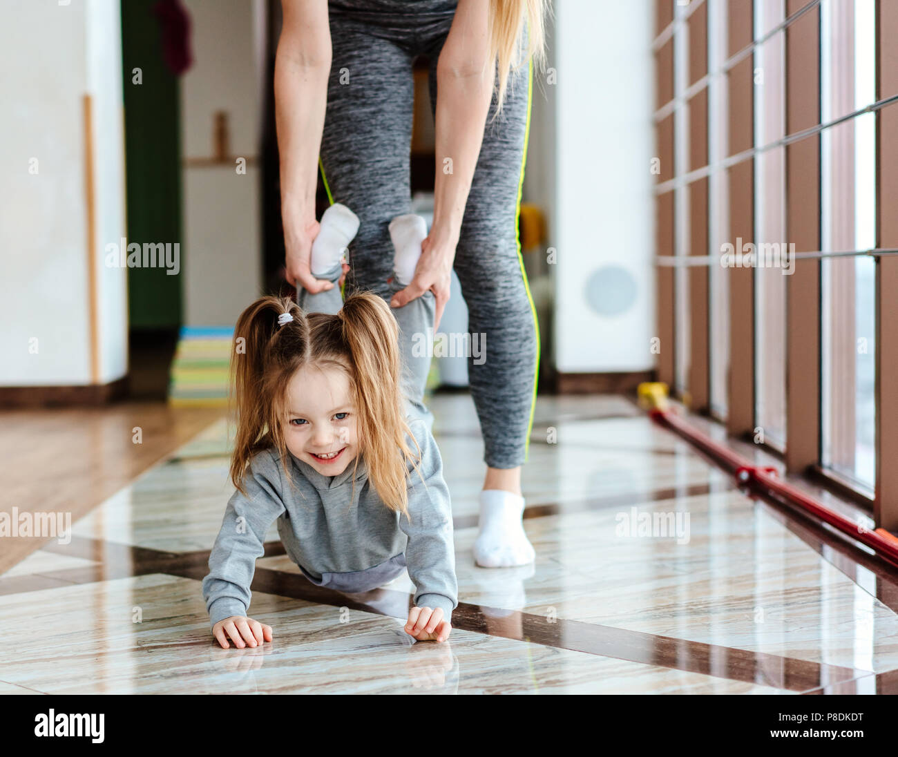 Little girl crawls on her hands Stock Photo - Alamy